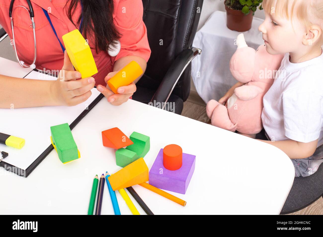 The doctor shows the multi-colored figures of the constructor to a ...