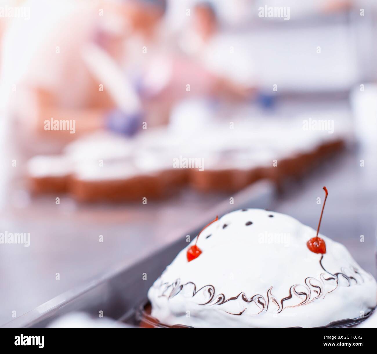 Mass production of cakes and sweets at the confectionery factory. Chefs ...