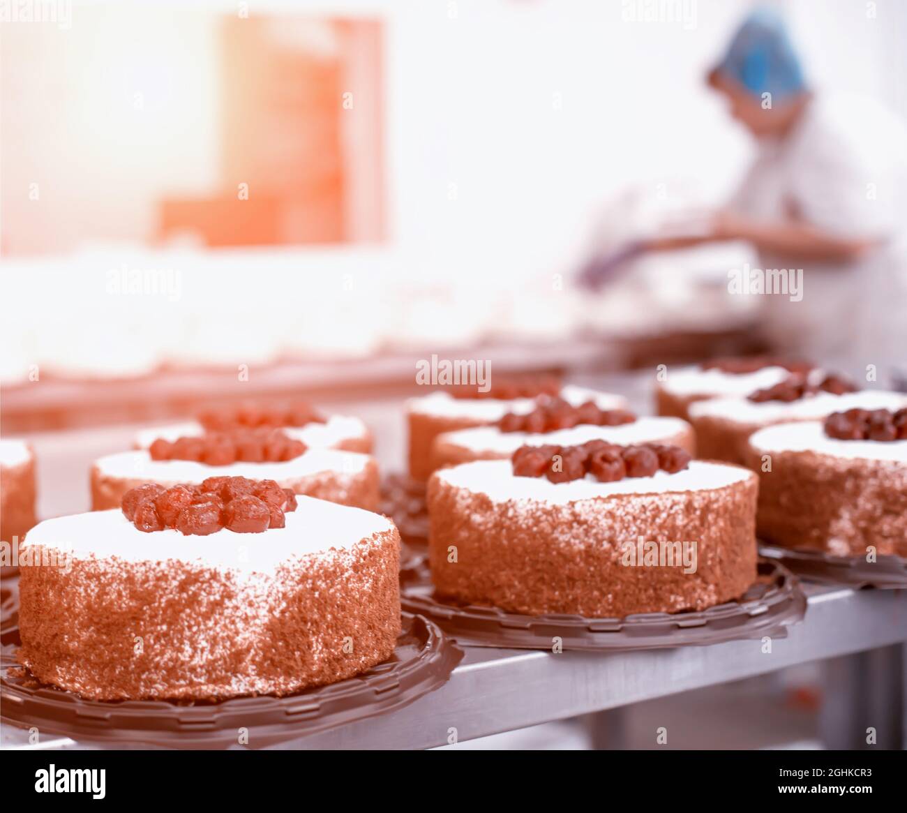 Pastry chef girl makes a cake from fresh biscuit berries and cream ...