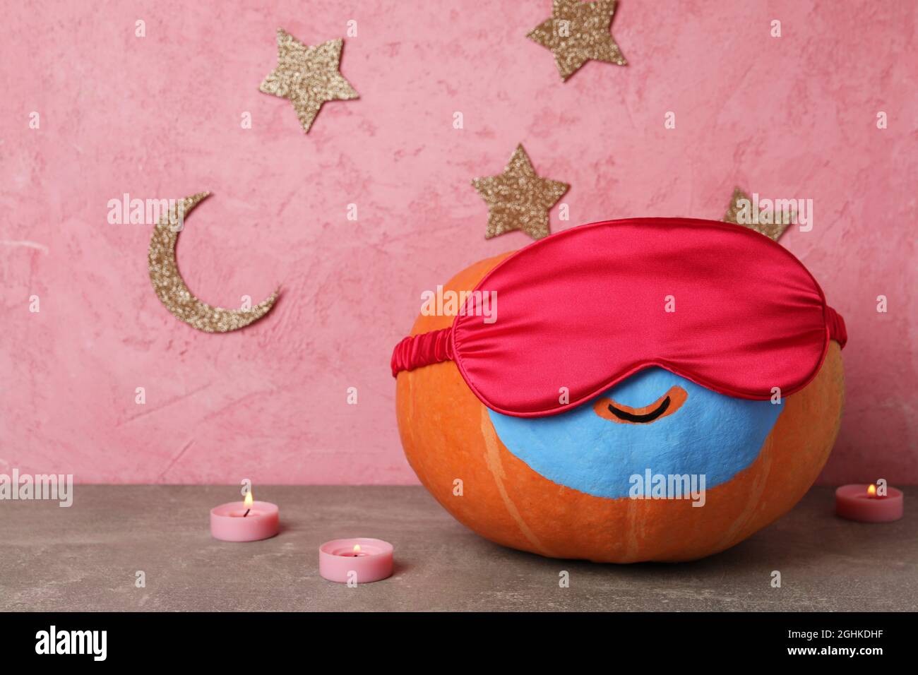 Healthy sleep concept with pumpkin against pink background Stock Photo ...
