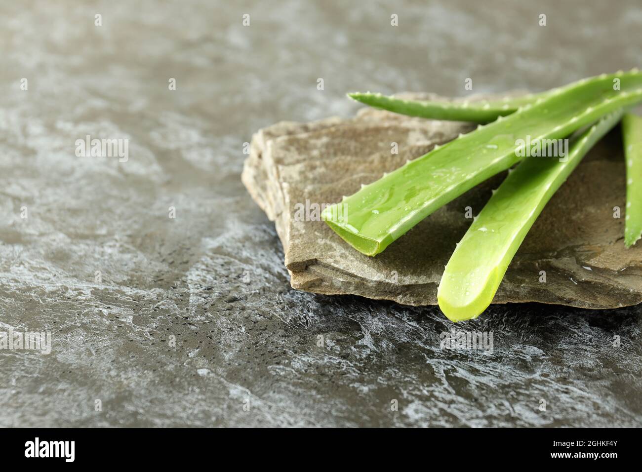 Aloe vera leaves and stone on black smokey background Stock Photo - Alamy