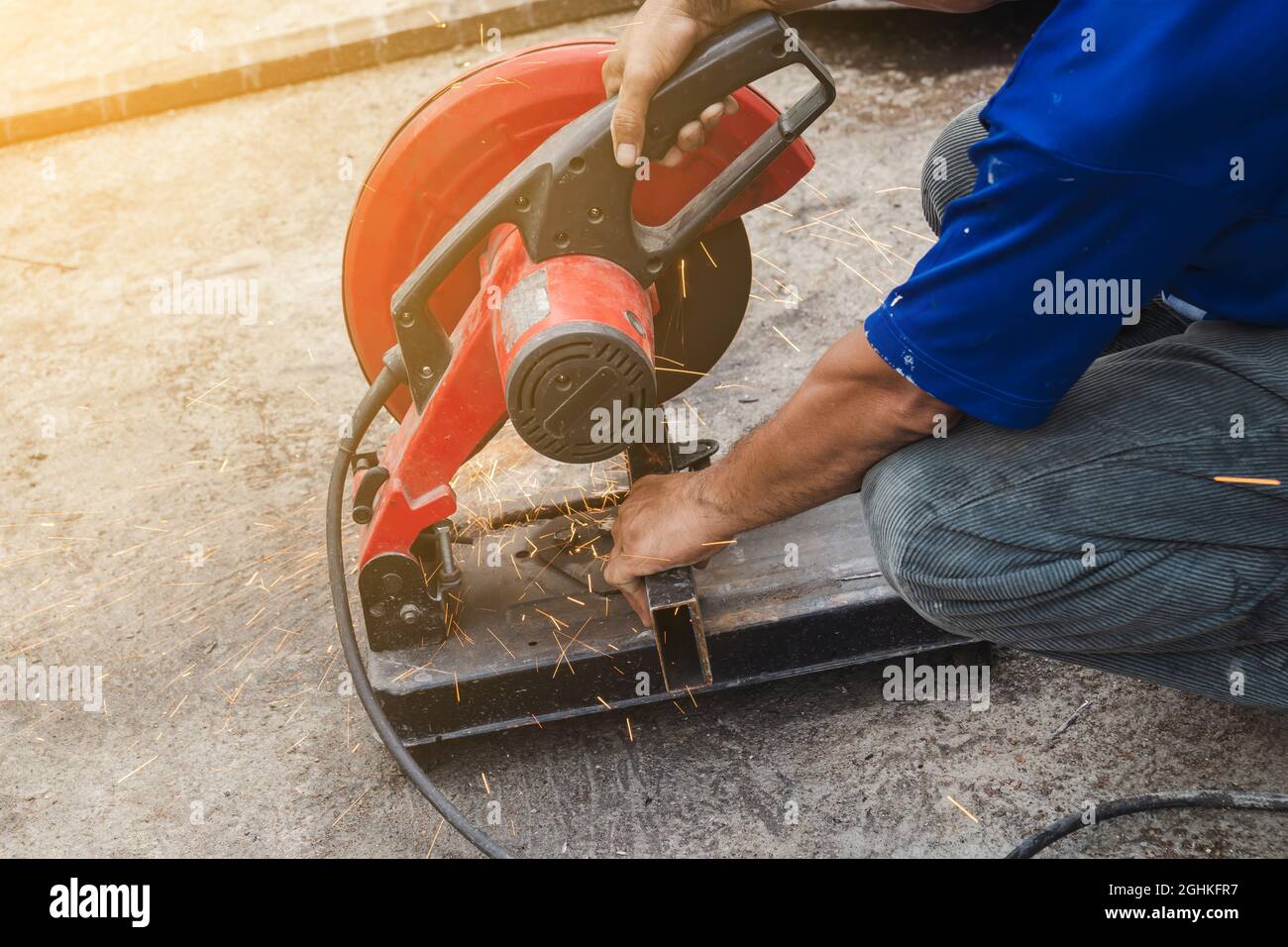 Worker man cutting steel with a circular steel cutter Stock Photo - Alamy