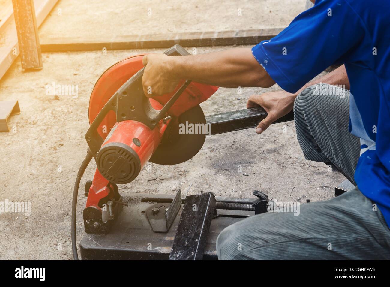 Worker man cutting steel with a circular steel cutter Stock Photo - Alamy