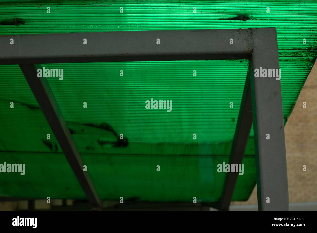 Green plastic roof on the structure. Simple roof on a metal profile ...