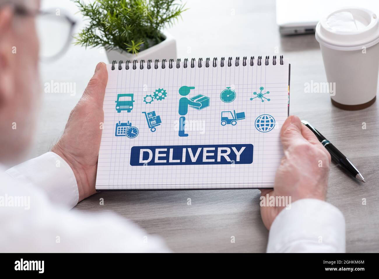 Hand holding a notepad with delivery concept Stock Photo - Alamy