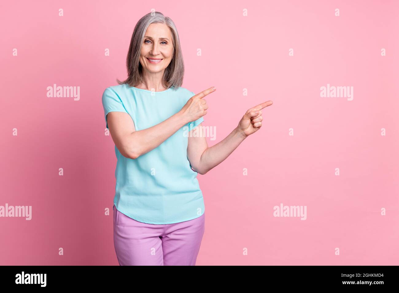 Photo of lovely elder grey hairdo lady point empty space wear teal ...