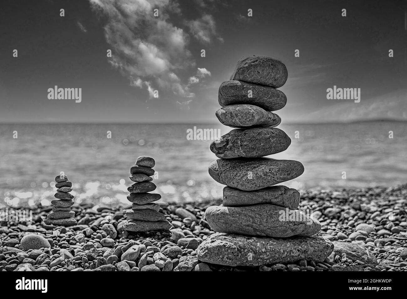 creating a composition by stacking stones at the seaside Stock Photo ...