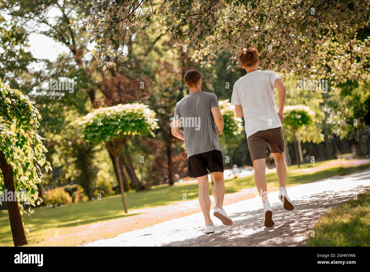 Back view jogging young hi-res stock photography and images - Alamy