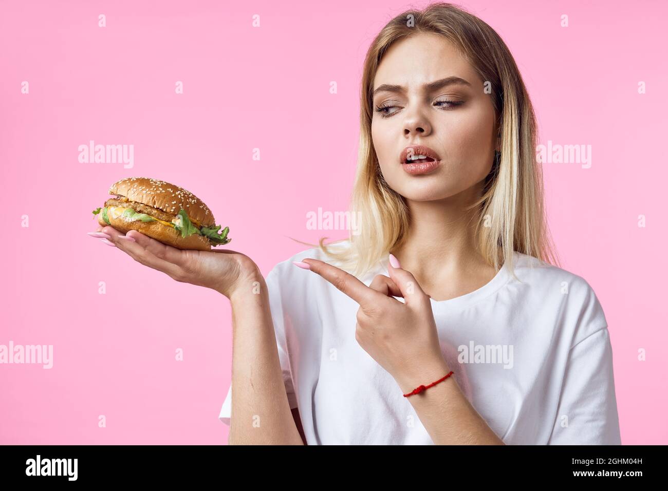 Young woman eating burger model hi-res stock photography and images - Alamy
