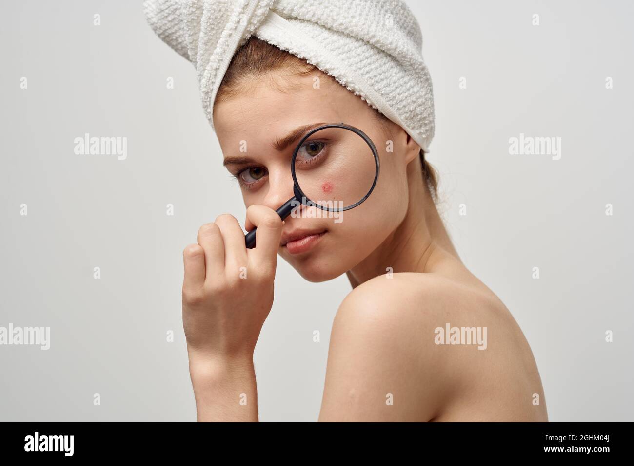 beautiful woman with a magnifying glass in hand skin problems Stock ...