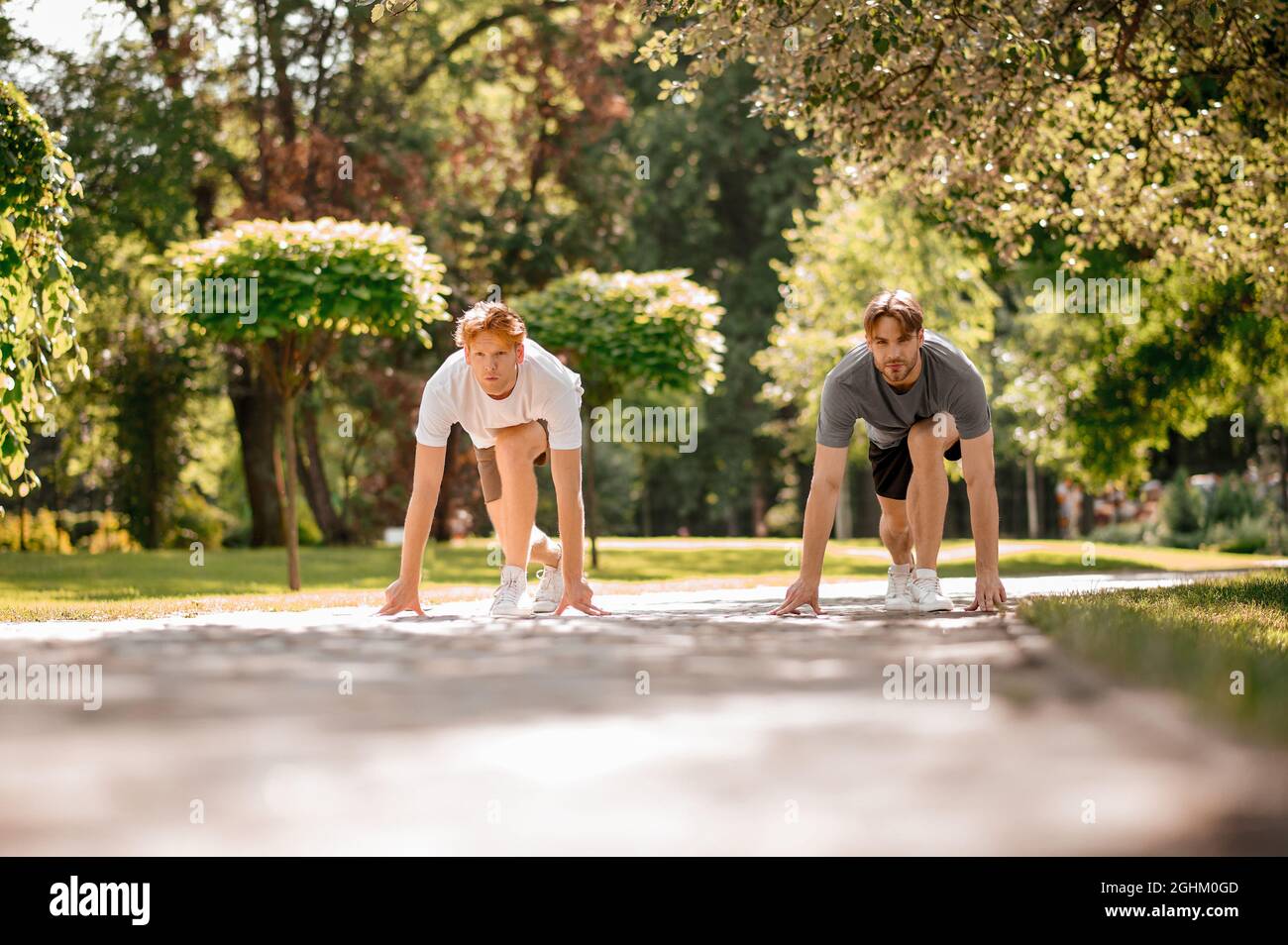 Two focused guys ready to start run Stock Photo - Alamy