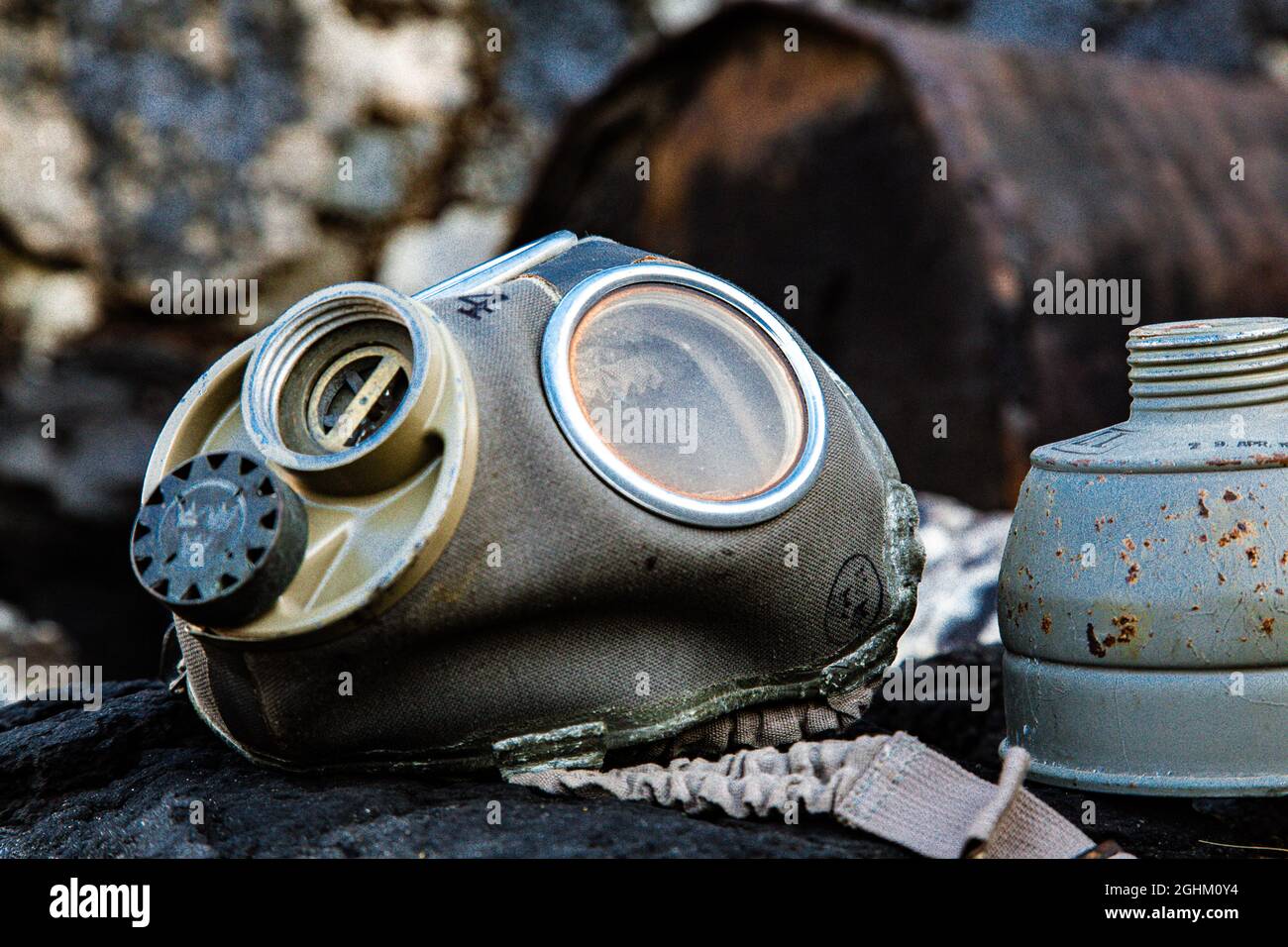 Weathered metal drum, in tar raft with gas mask Stock Photo - Alamy