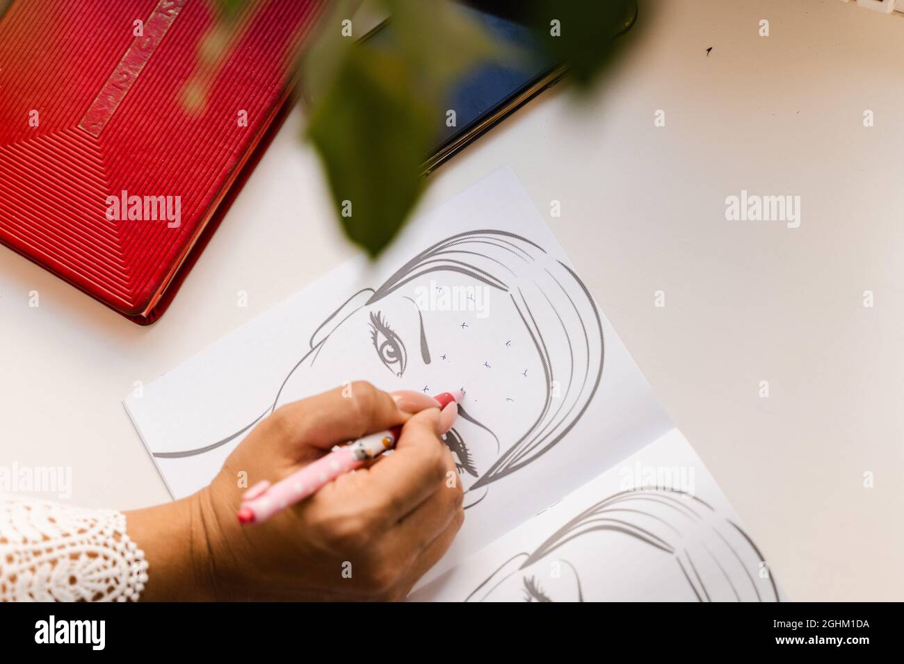 Beautician drawing zone of mimic activity in the patient chart in the ...