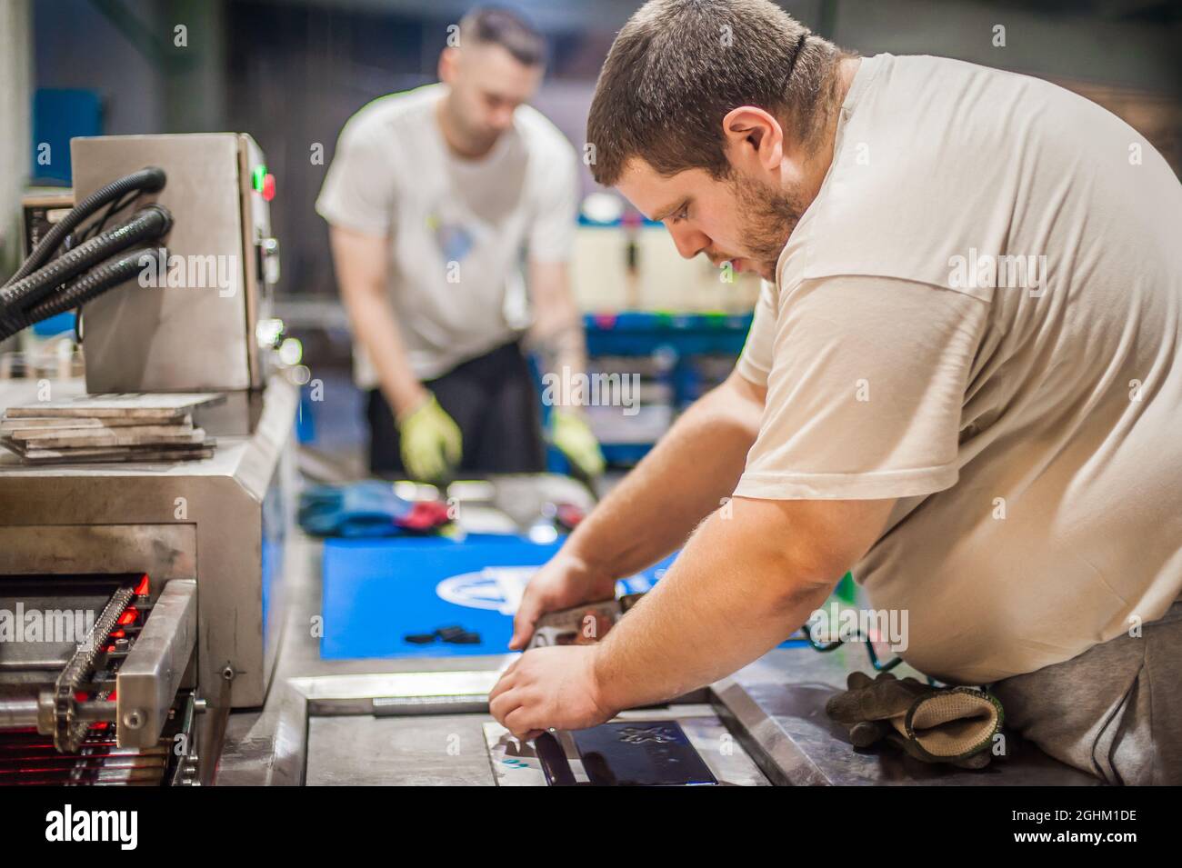 Professional worker technician machinist work in factory production ...
