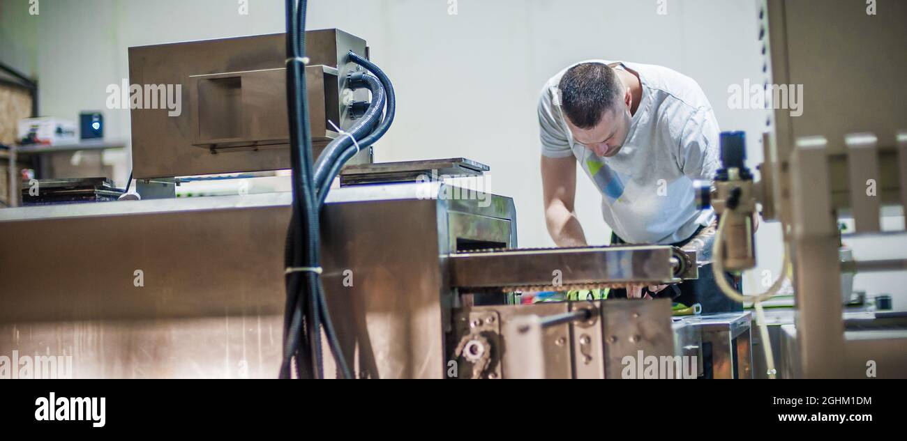 Professional worker technician machinist work in factory production ...