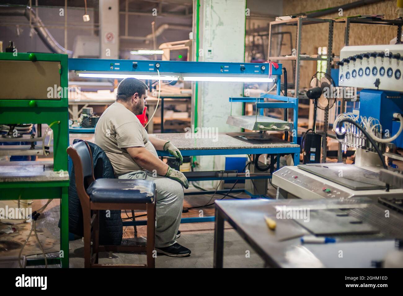 Professional worker technician machinist work in factory production ...