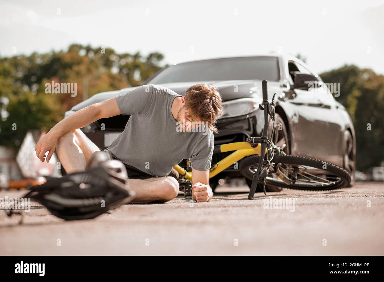 Lost guy felling from bike on road Stock Photo - Alamy