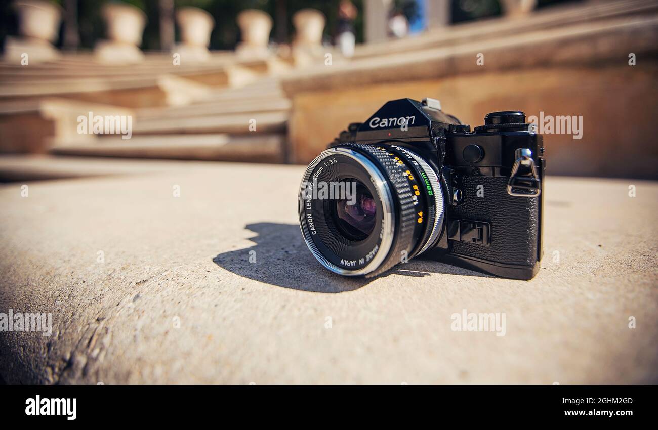 Canon A-1 Film Camera sitting on concrete bench next to steps with ...