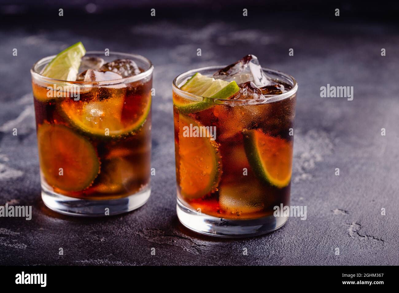 Rum and Cola cocktail Cuba Libre with lime and ice Stock Photo - Alamy