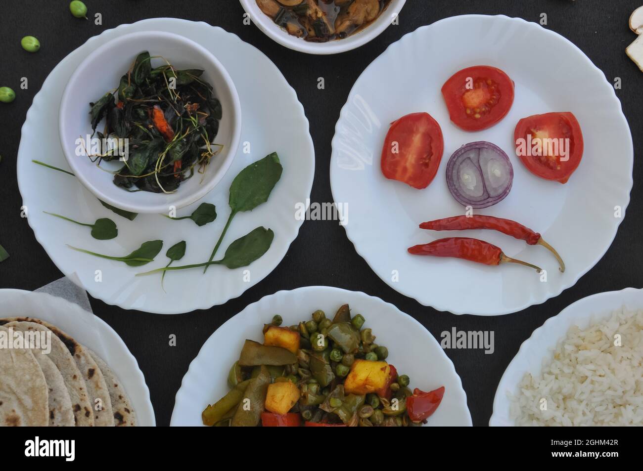 Indian Food - High angle view of mushroom soup, saag (greens), salad ...