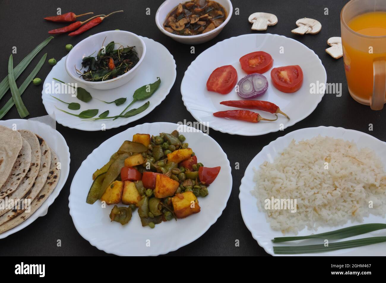 Indian Food: Flat lay of mushroom soup, saag (greens), salad, chapati ...
