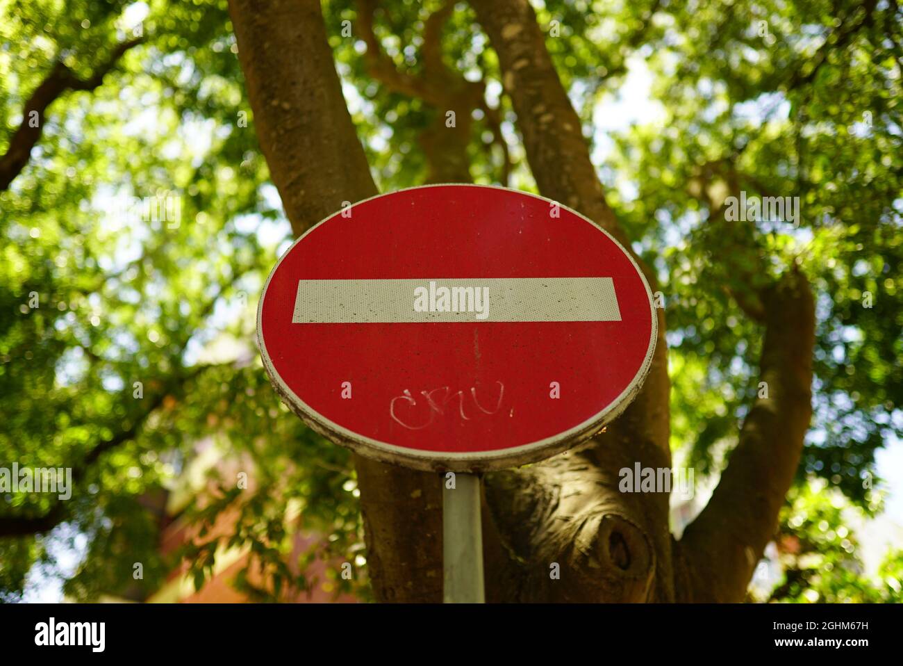 Closeup shot of a red no entry sign with a white horizontal line in ...
