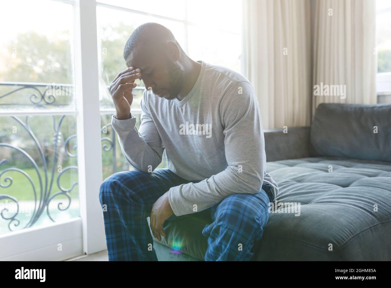 Man sitting on couch thinking hi-res stock photography and images - Alamy