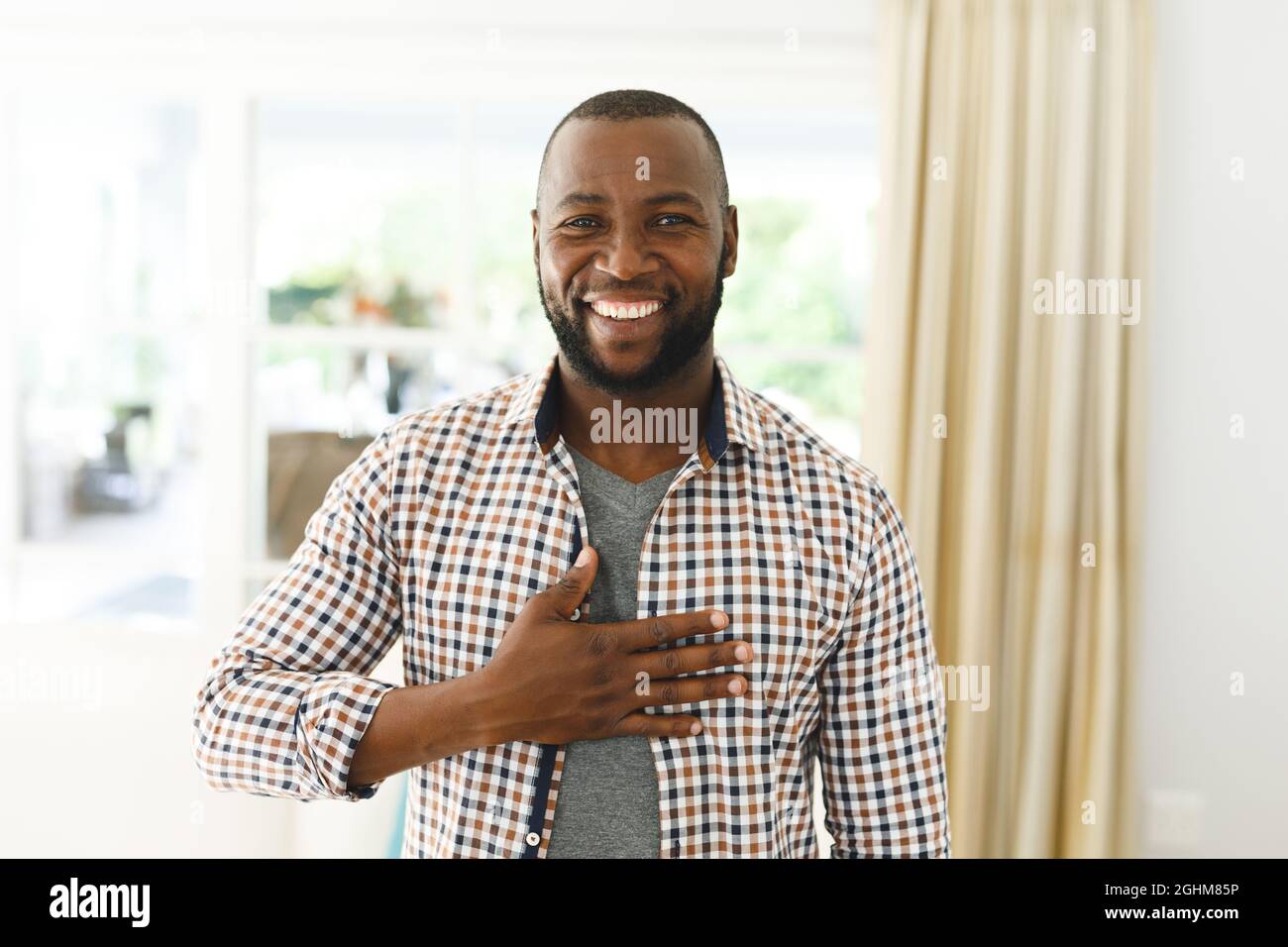 Portrait of african american man smiling and looking at camera in ...
