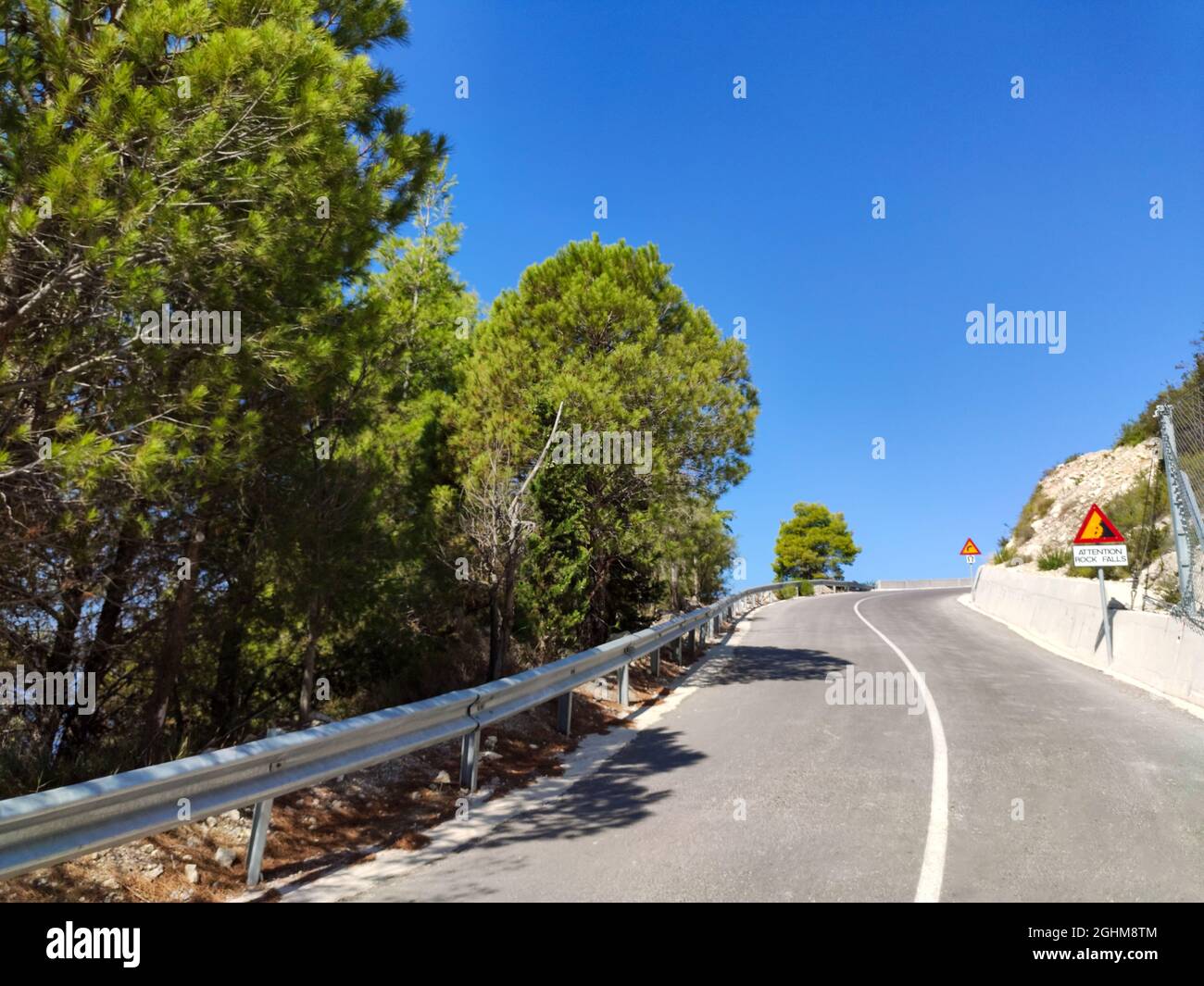 Driving mountain serpentine steep road with warning signs from Gialos ...