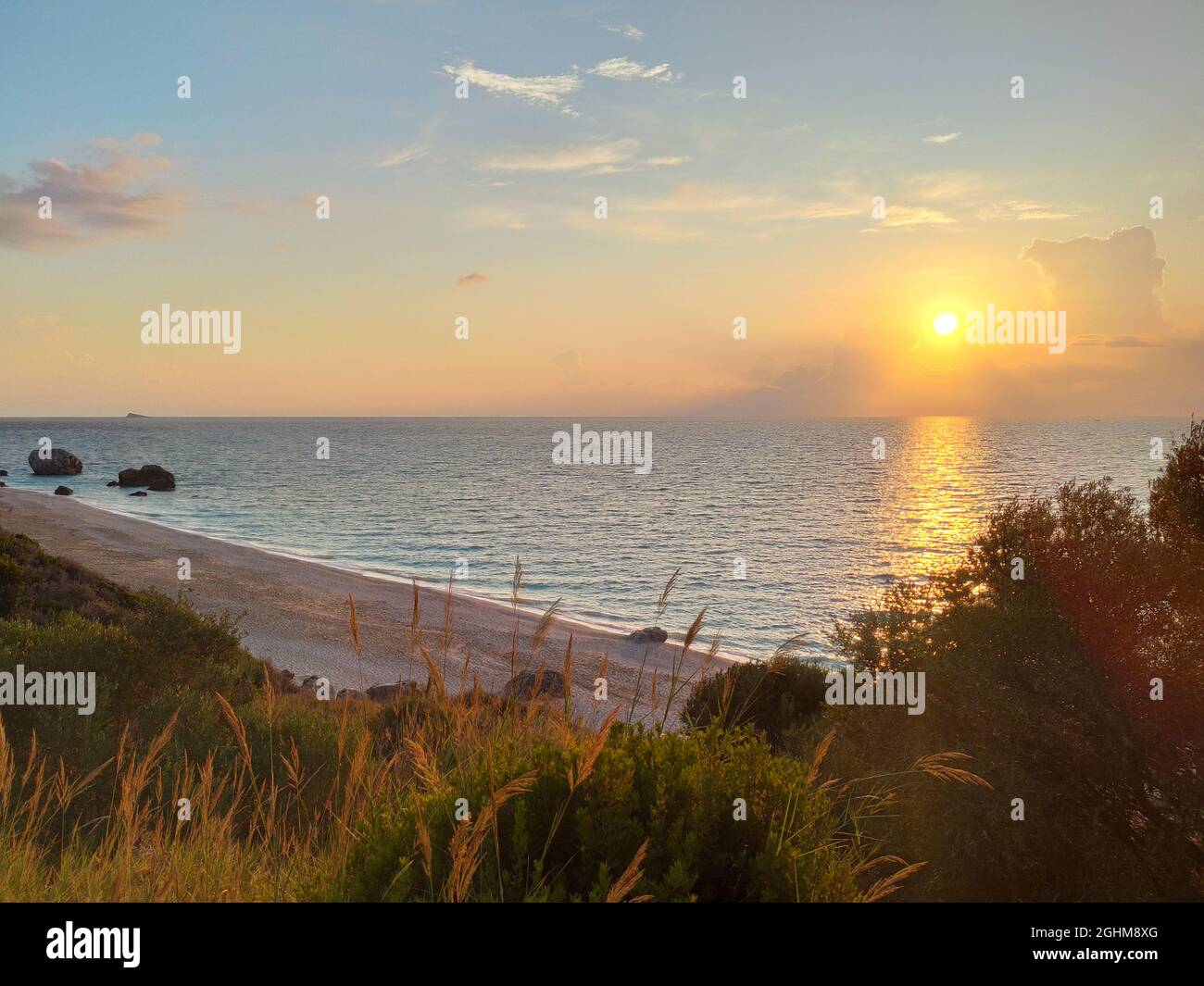 Scenic sunset on Megali Petra beach, tide waves with pebble stones in ...