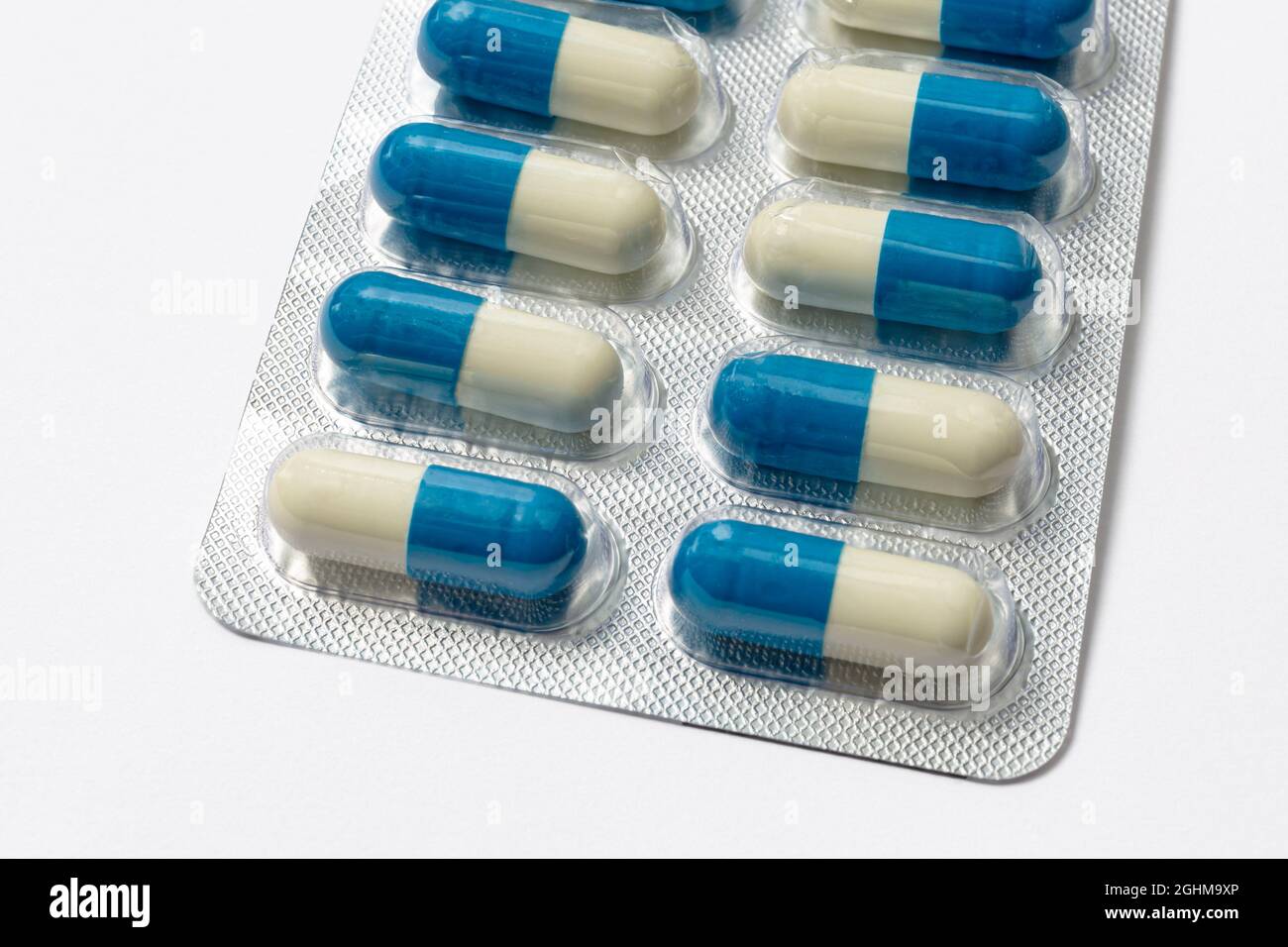 Blue and white capsules close up Stock Photo - Alamy
