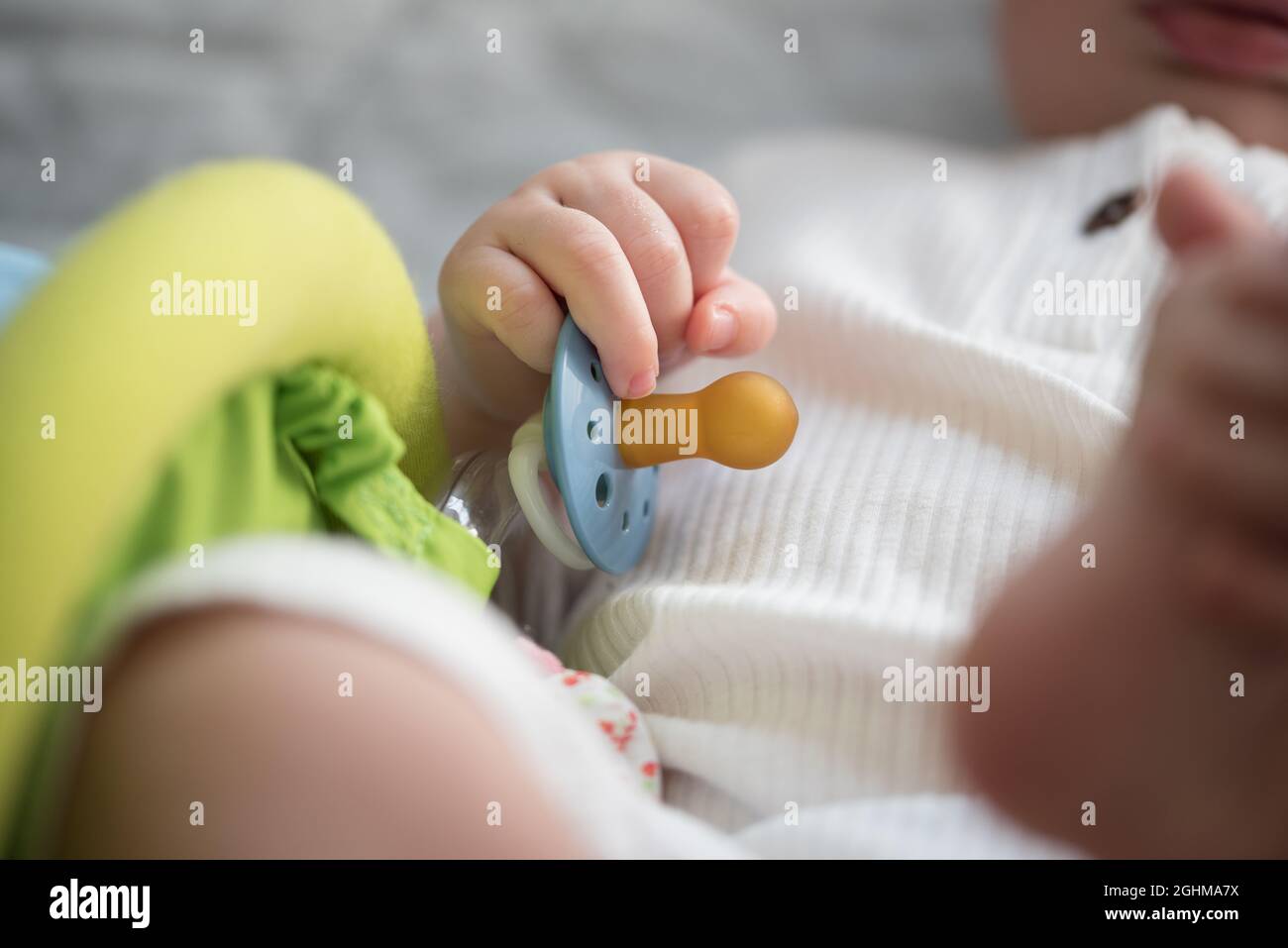 close-up view of hand of baby holding pacifier Stock Photo - Alamy