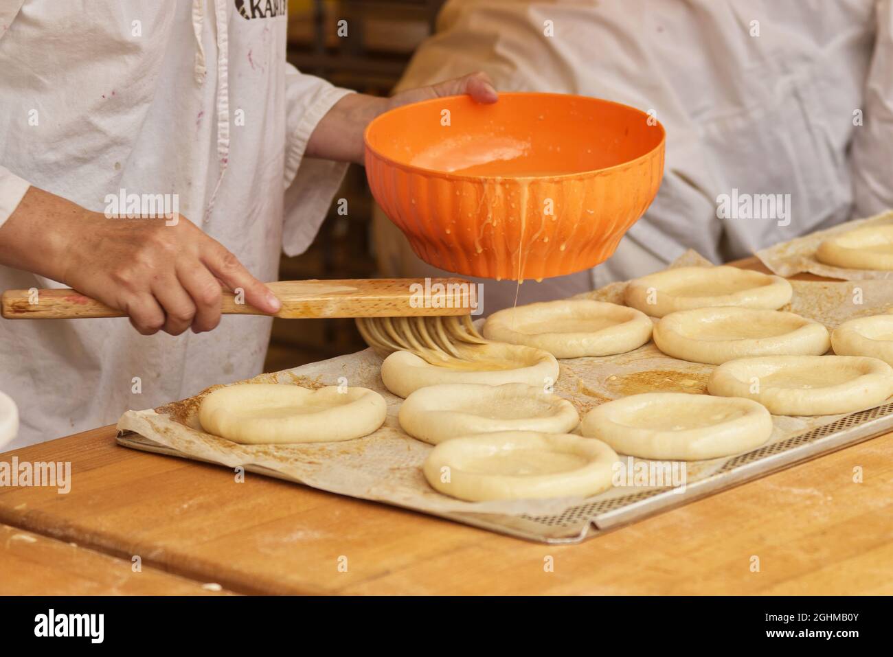 The woman in the picture is making filled pies. Hands wearing ...