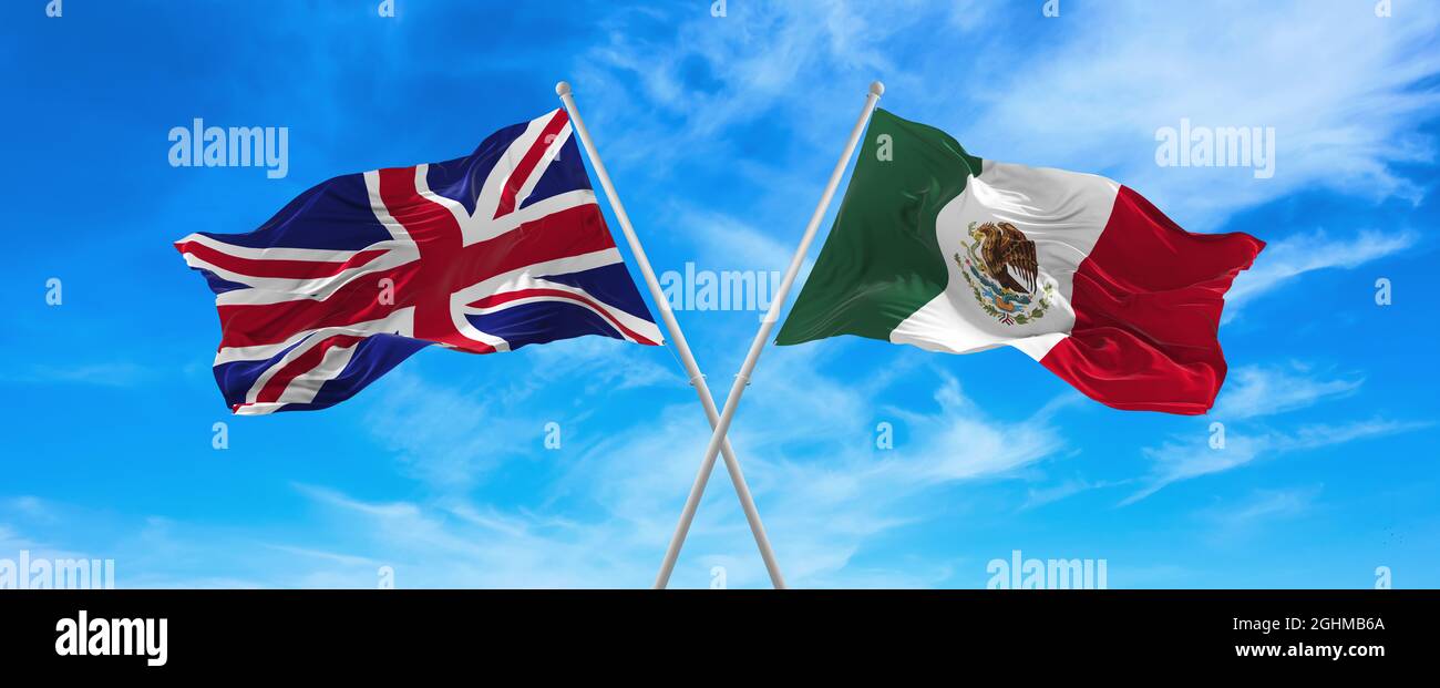 flags of great Britain and Mexico waving in the wind on flagpoles ...
