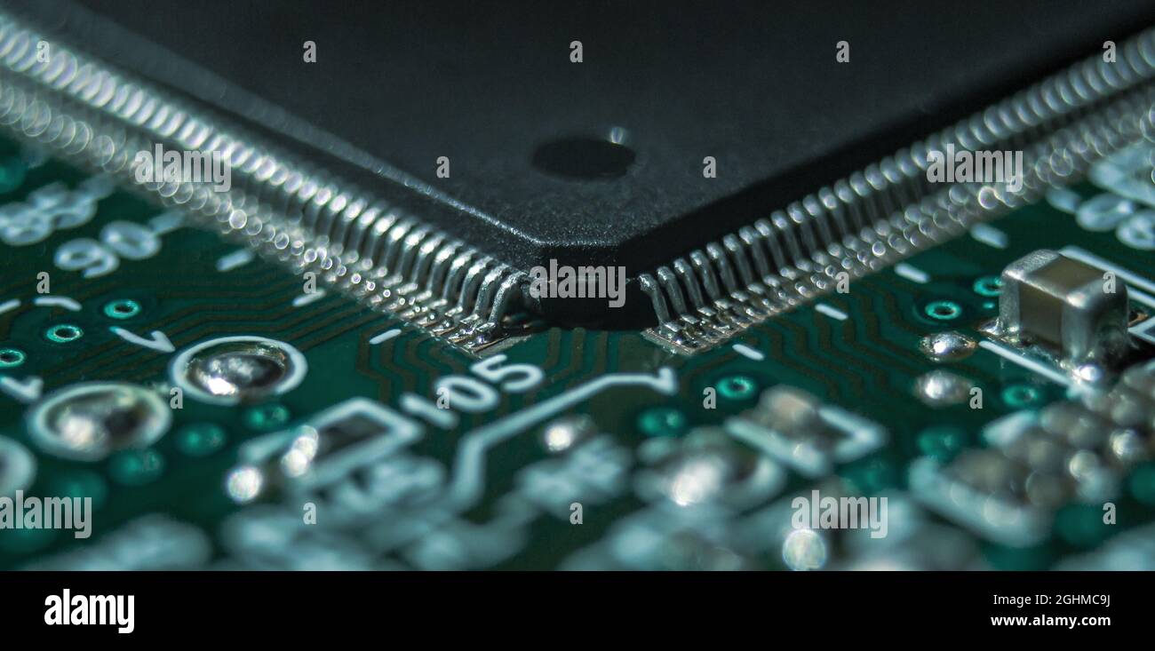 macro photography of integrated circuit in QFP package assembled on ...