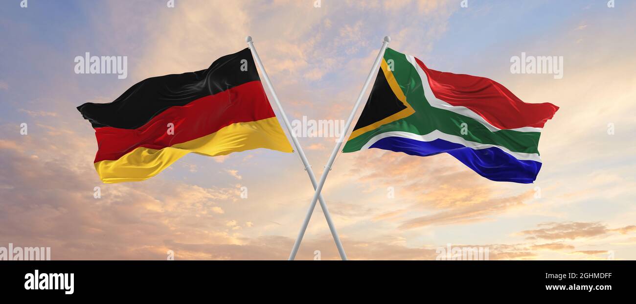flags of Germany and South Africa waving in the wind on flagpoles ...