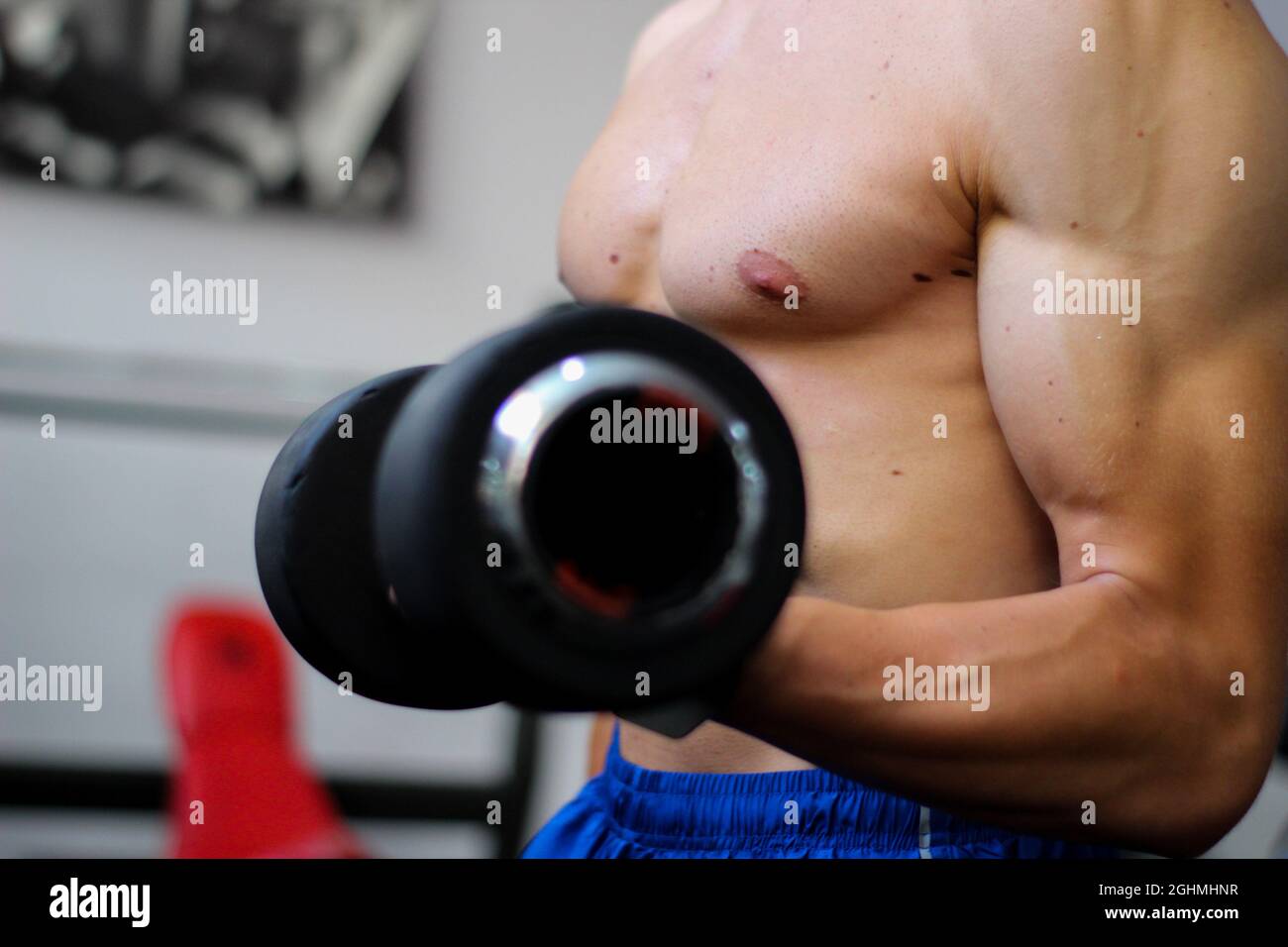 Closeup shot of a man's arm performing biceps exercise in the gym Stock ...