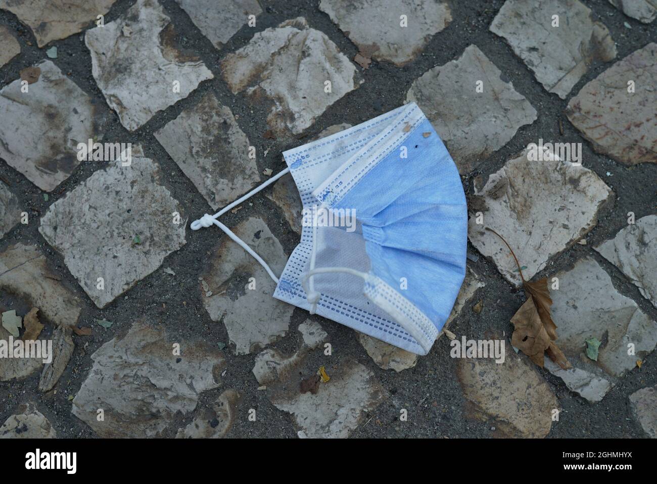 Closeup shot of a medical face mask laying on the ground outside Stock ...