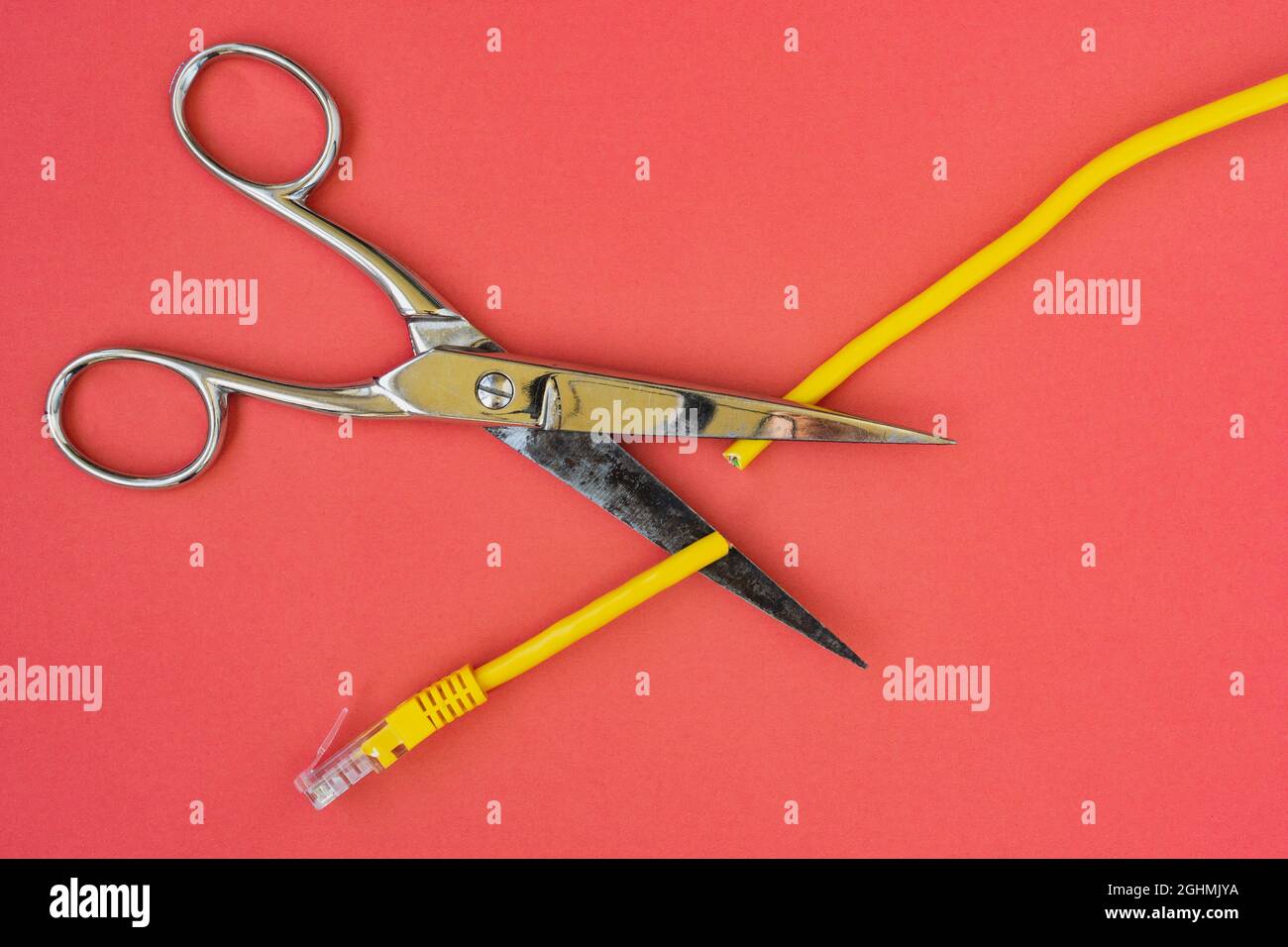 Scissors cutting the yellow network cable. Prohibit and restrict access ...