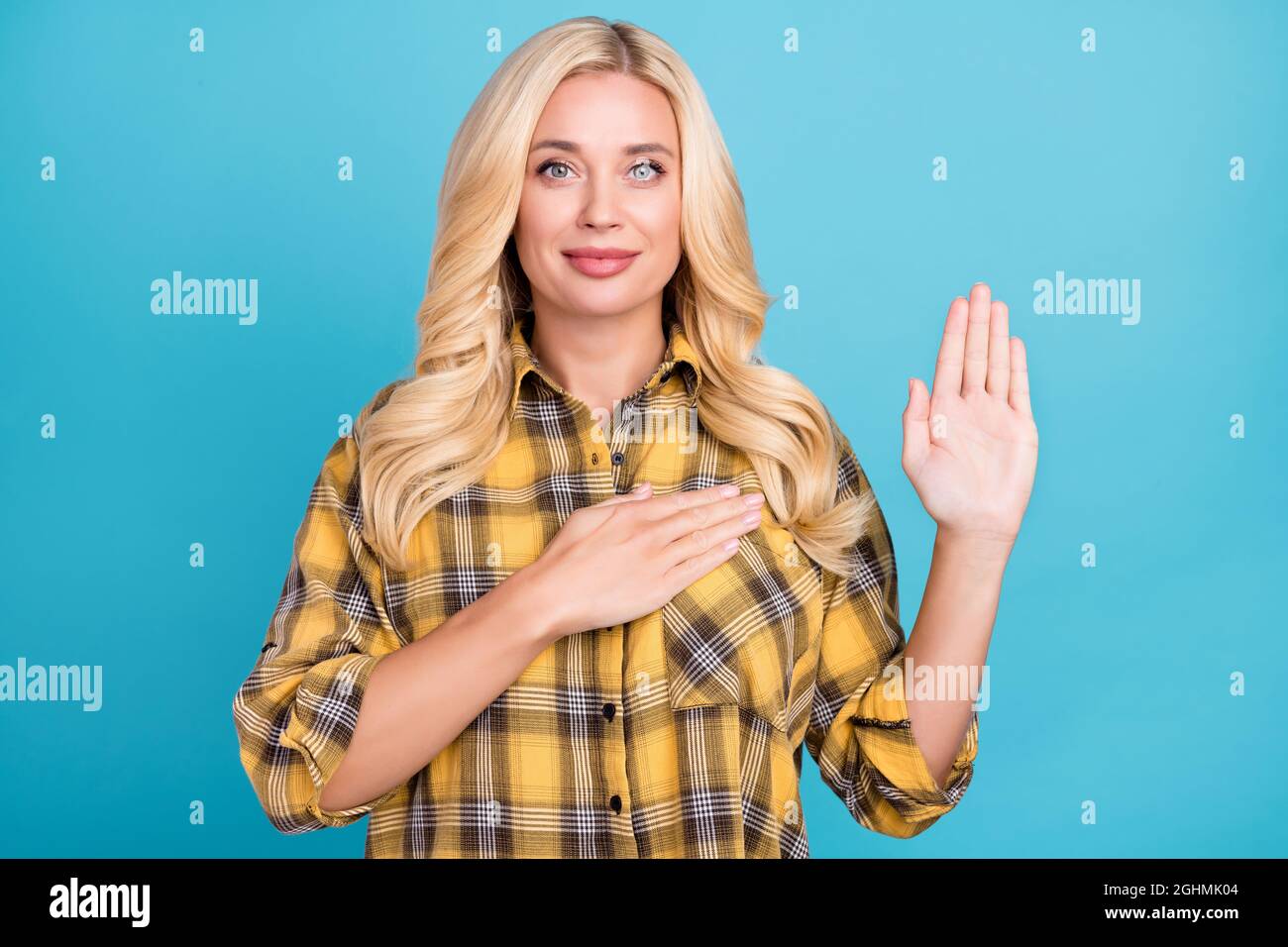 Portrait of lovely confident honest wavy-haired woman giving promise ...