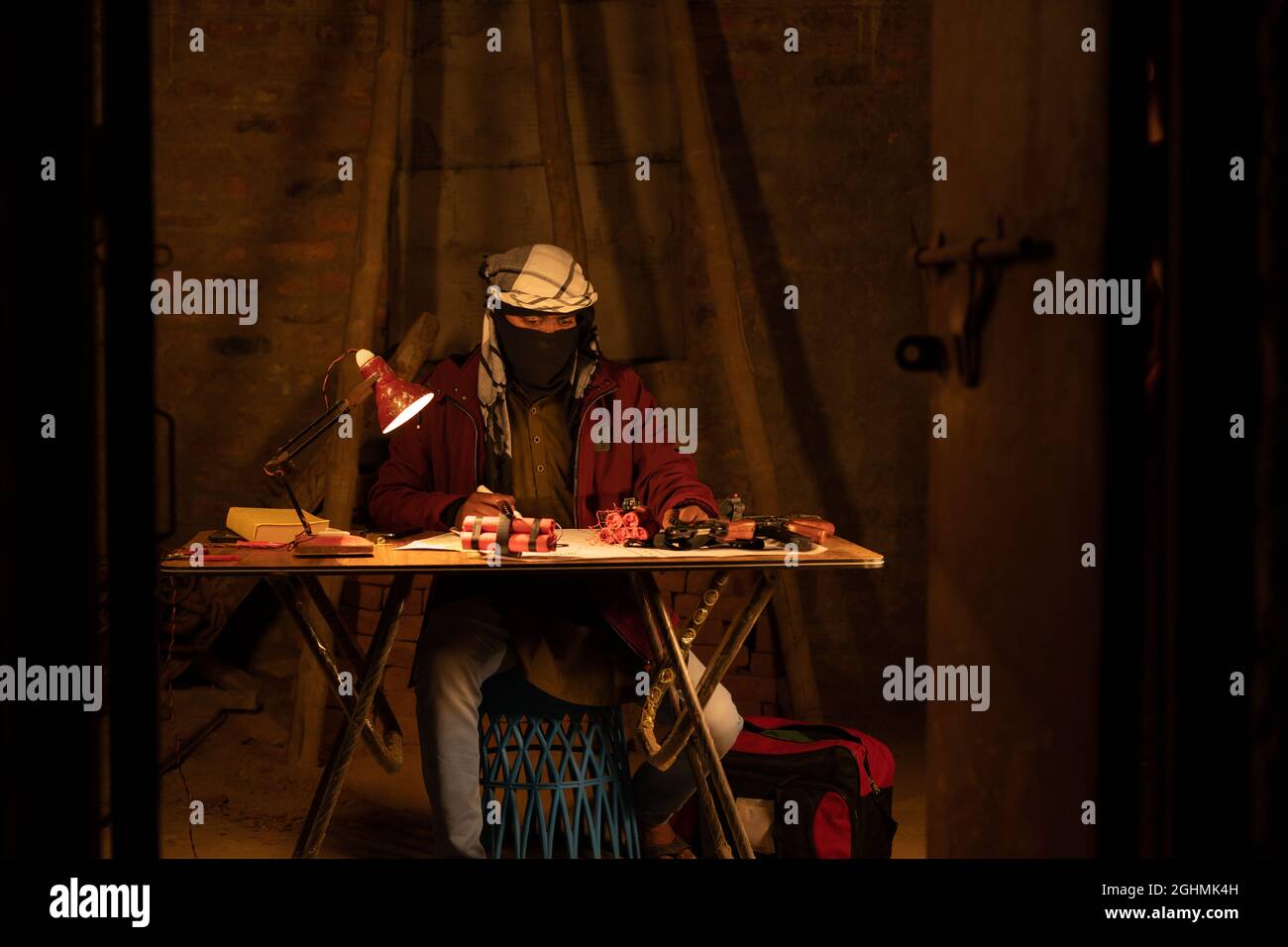 wide shot of unrecognizable militent or mafia gangaster with face cover ...