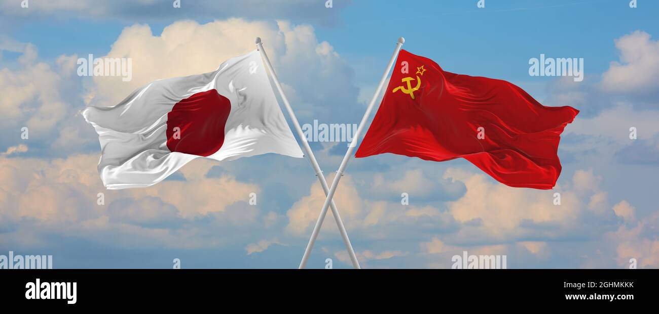 flags of Japan and ussr waving in the wind on flagpoles against sky ...