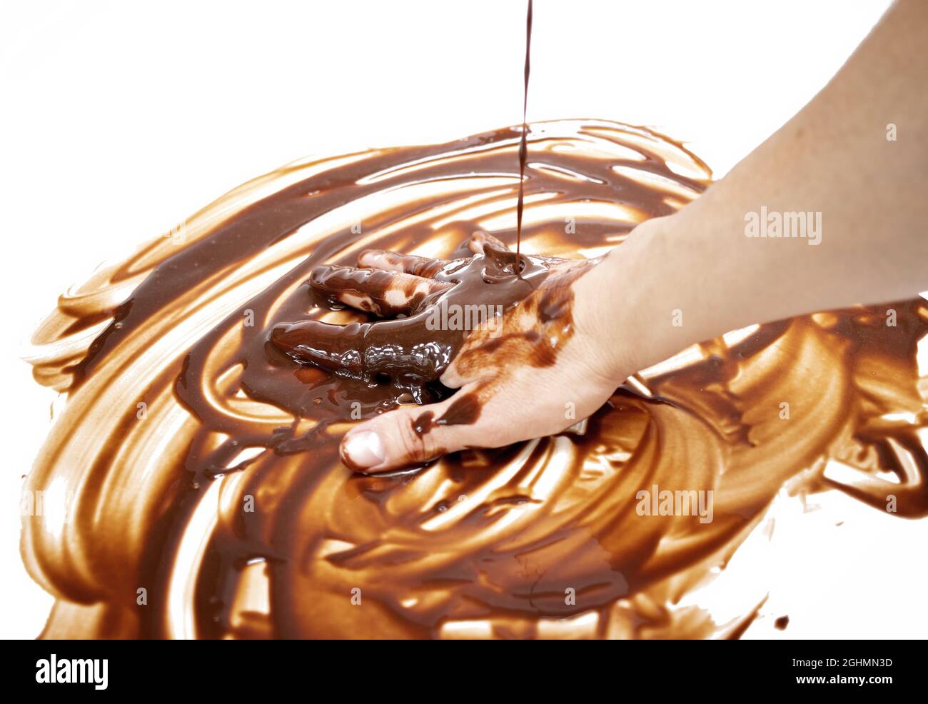 Spilling chocolate in a hand on white background Stock Photo - Alamy