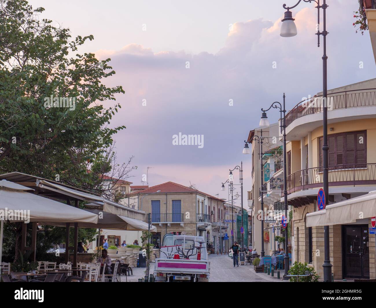 Lorry car with freight moving along central street of Larnaca old town ...