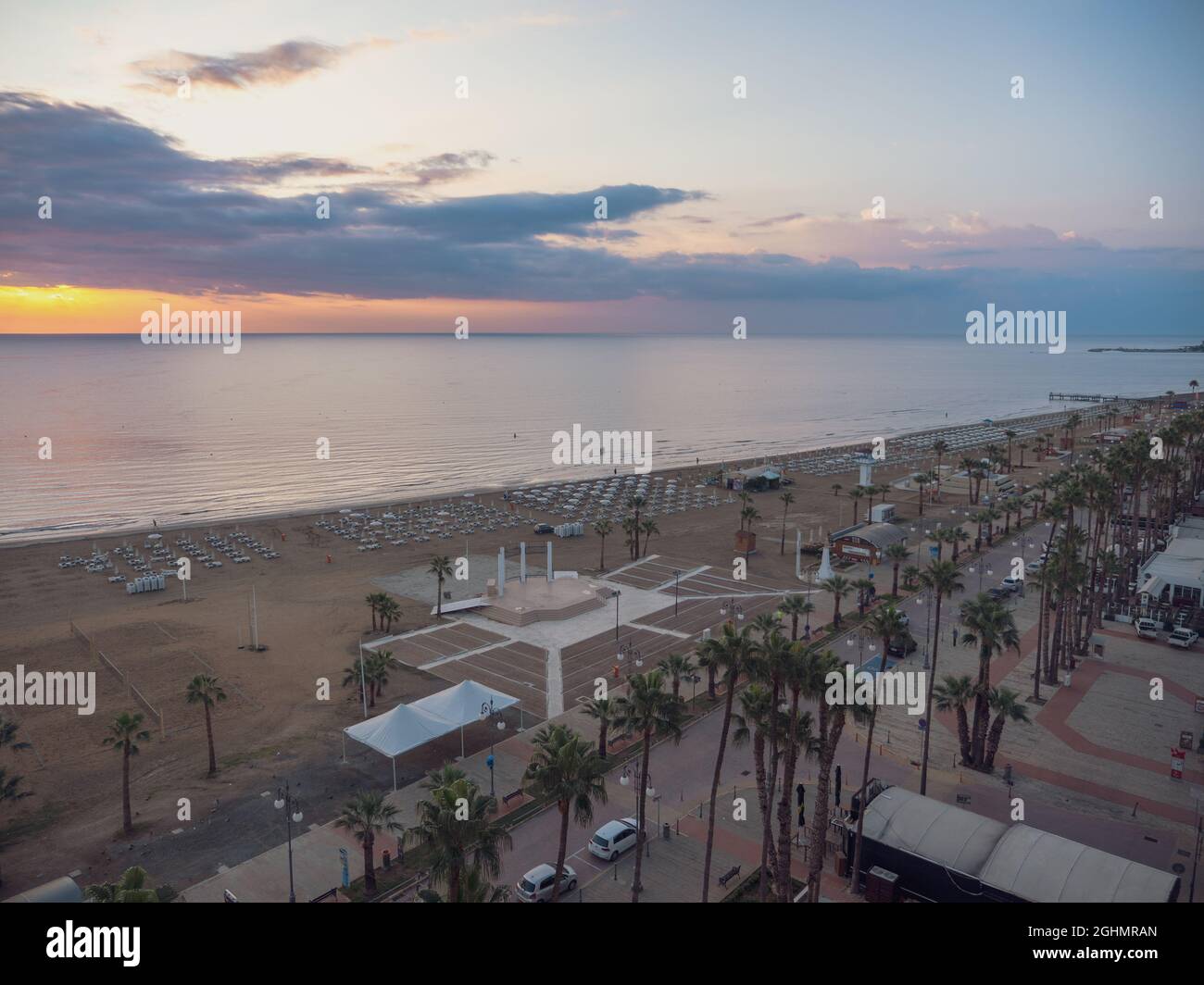 Top aerial view overlooking Finikoudes Palm tree promenade, volleyball ...