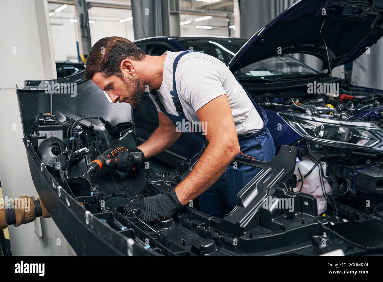 Mechanic working on electric car hi-res stock photography and images ...