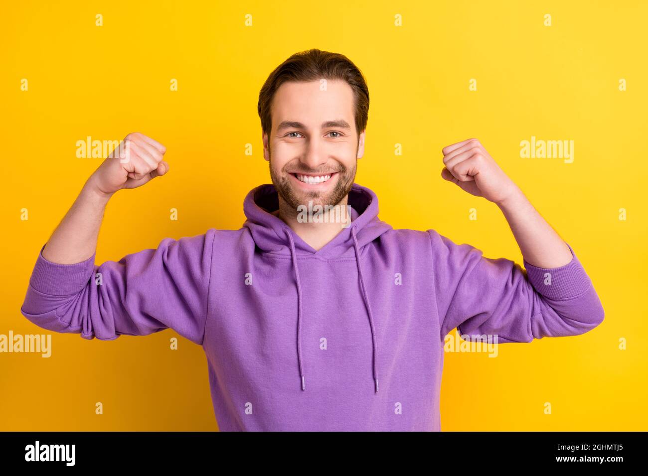 Photo of young guy happy positive smile sportsman show arms muscles ...