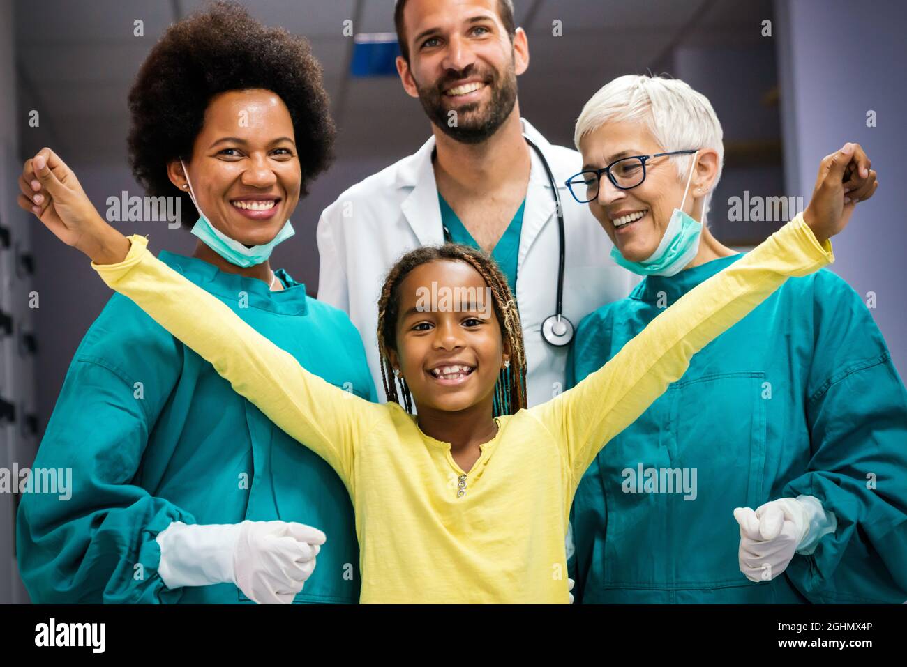 Team of experienced highly qualified doctors with child patient after a ...