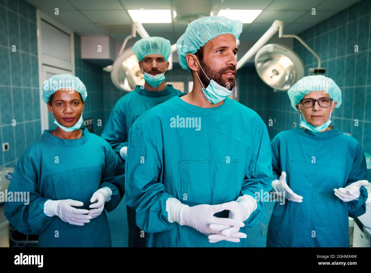 Successful team of surgeon standing in operating room, ready to work on ...