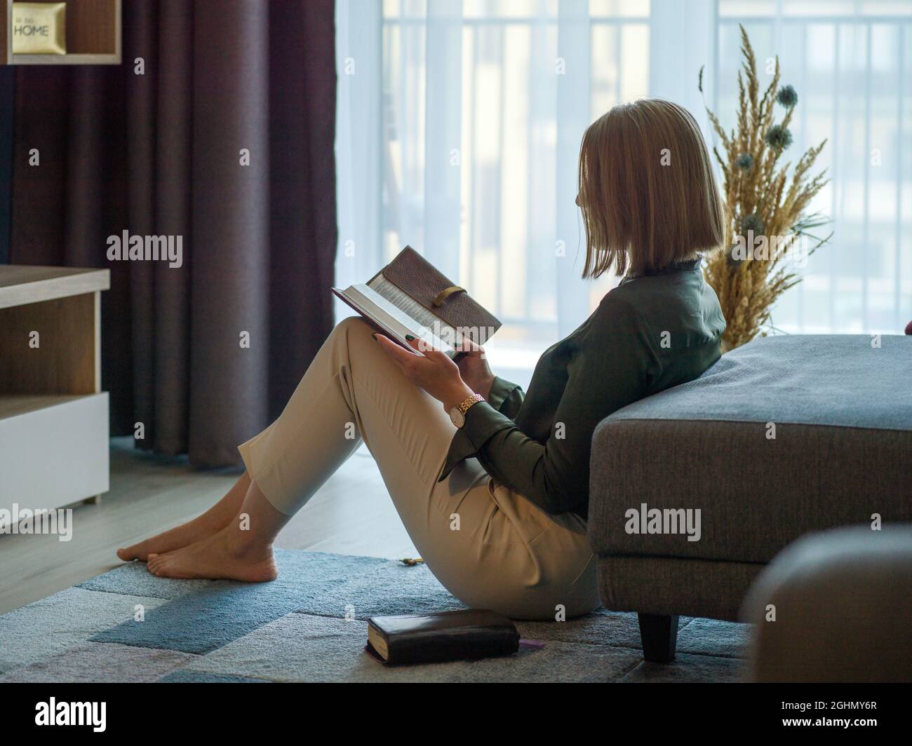 View of a woman reading a Bible Stock Photo - Alamy